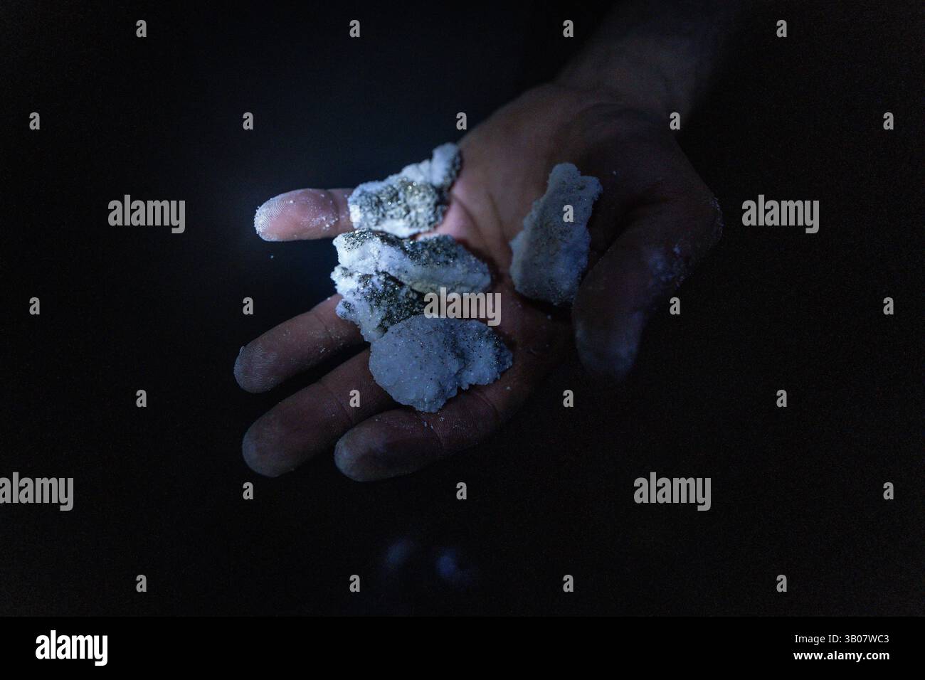 Miners work at Trepca mining complex, in Kosovo A miner holds minerals ...