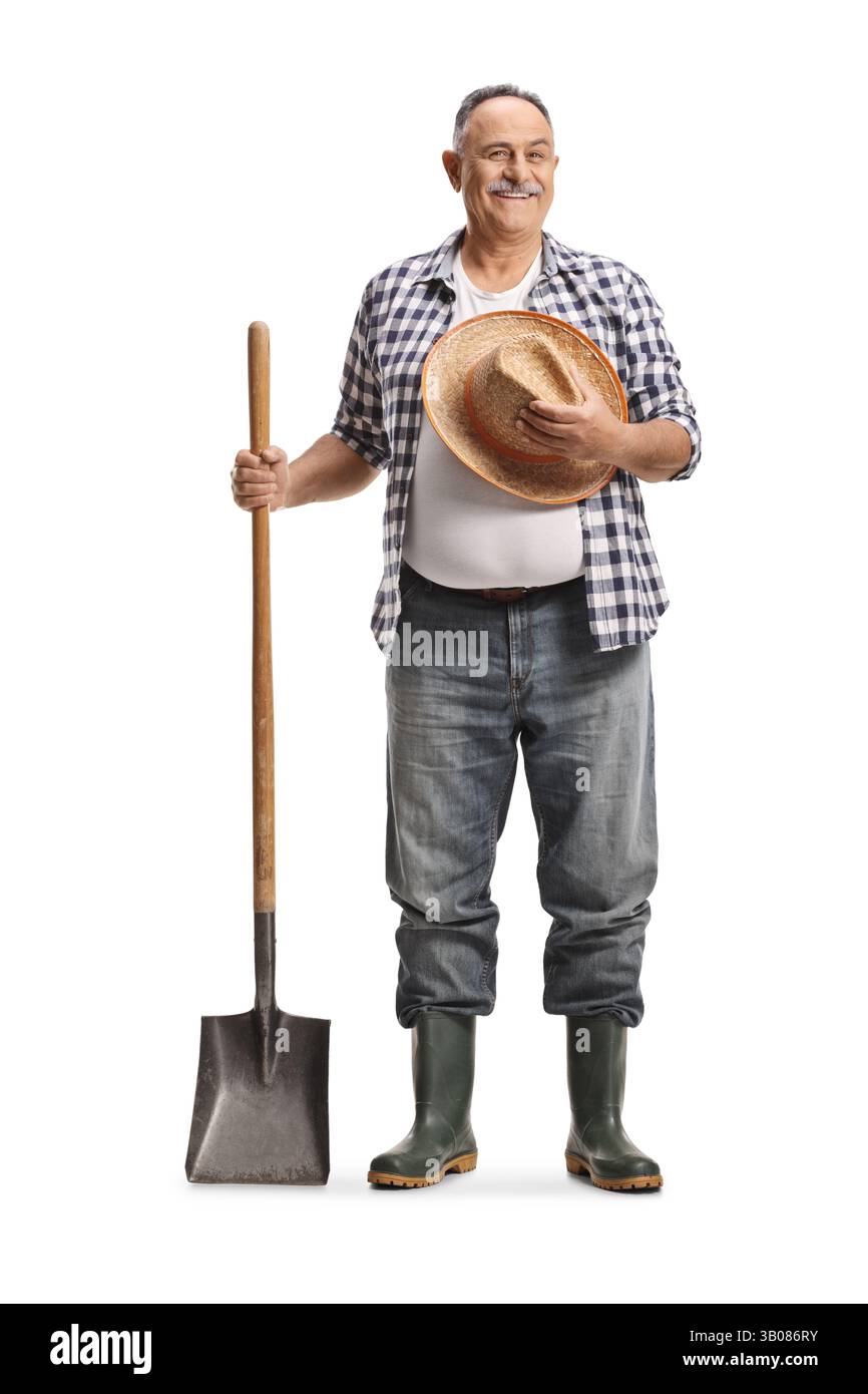 Full length portrait of a mature farmer with a straw hat and a spade ...