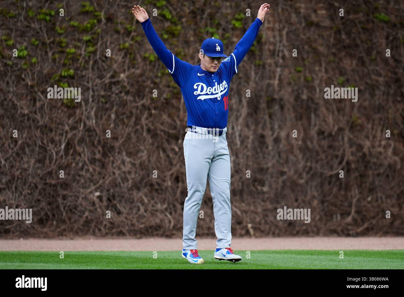 Los Angeles Dodgers pitcher Yoshinobu Yamamoto warms up before a ...