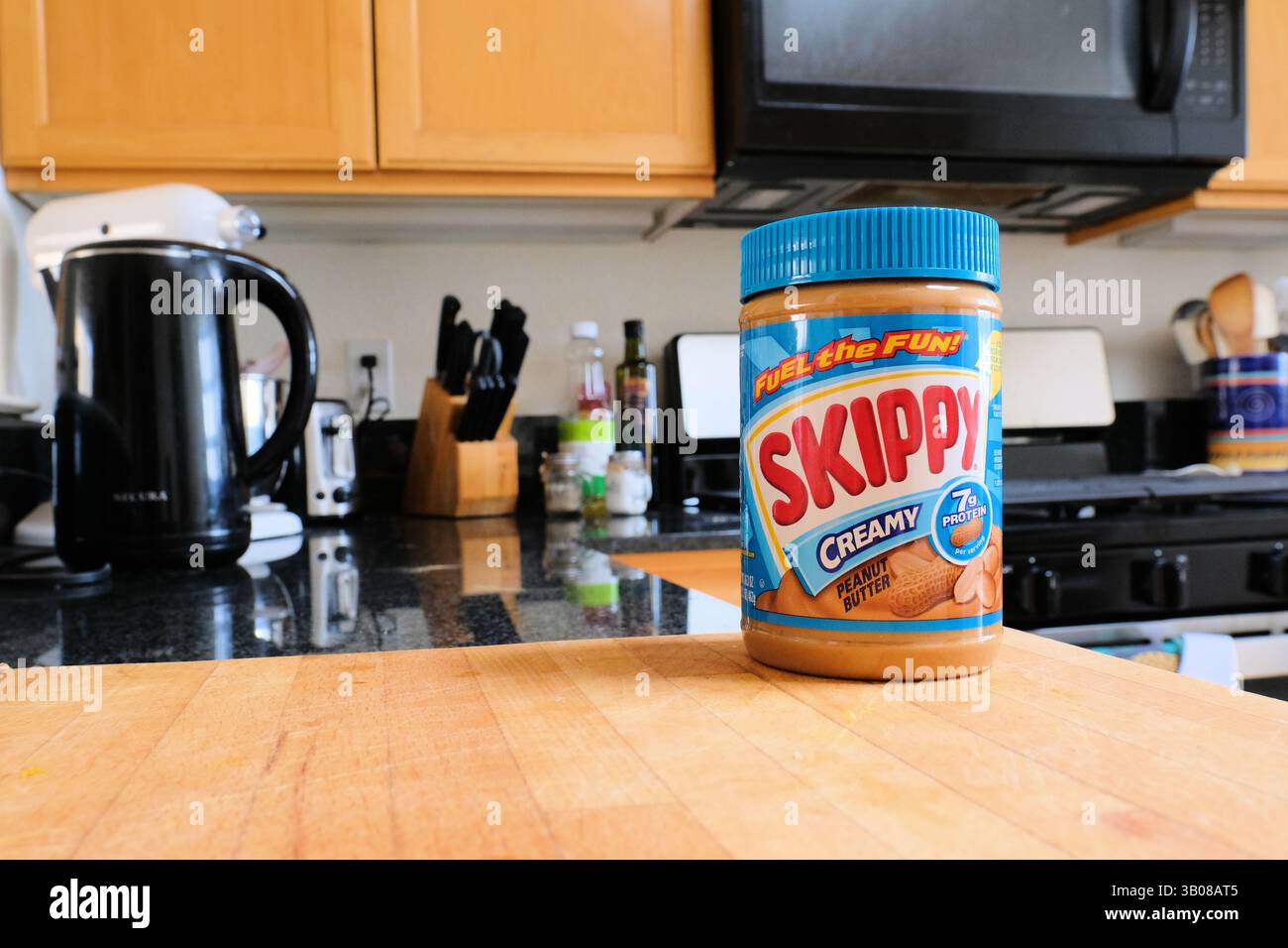 A 16.3 ounce or 462 gram jar of Skippy creamy peanut butter on a ...