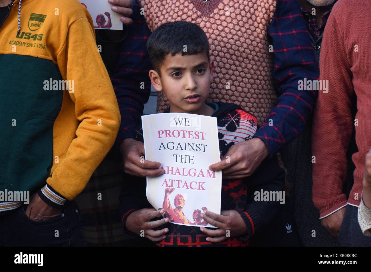 Srinagar, India. 23rd Apr, 2025. A child holding a placard while take ...