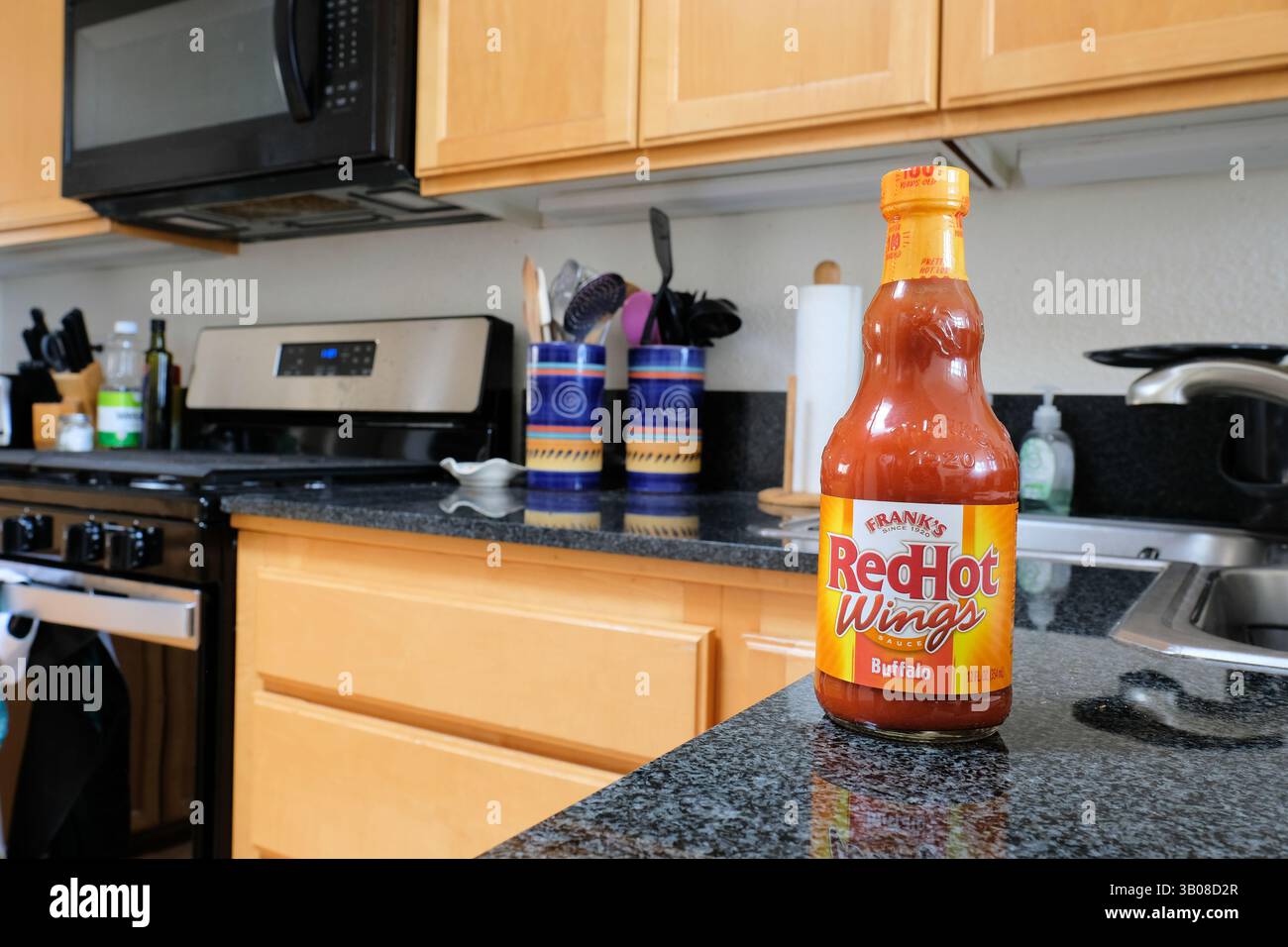 A glass bottle of Frank's RedHot Buffalo Wings Sauce on a kitchen ...