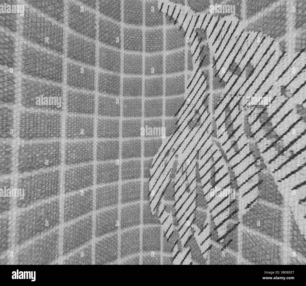 A textured surface featuring a grid pattern with stylized lettering ...