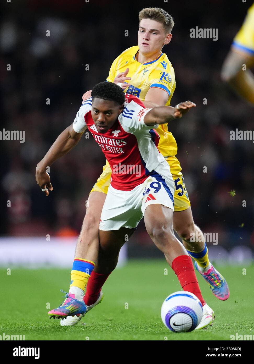 Arsenal's Myles Lewis-Skelly (left) and Crystal Palace's Justin Devenny ...