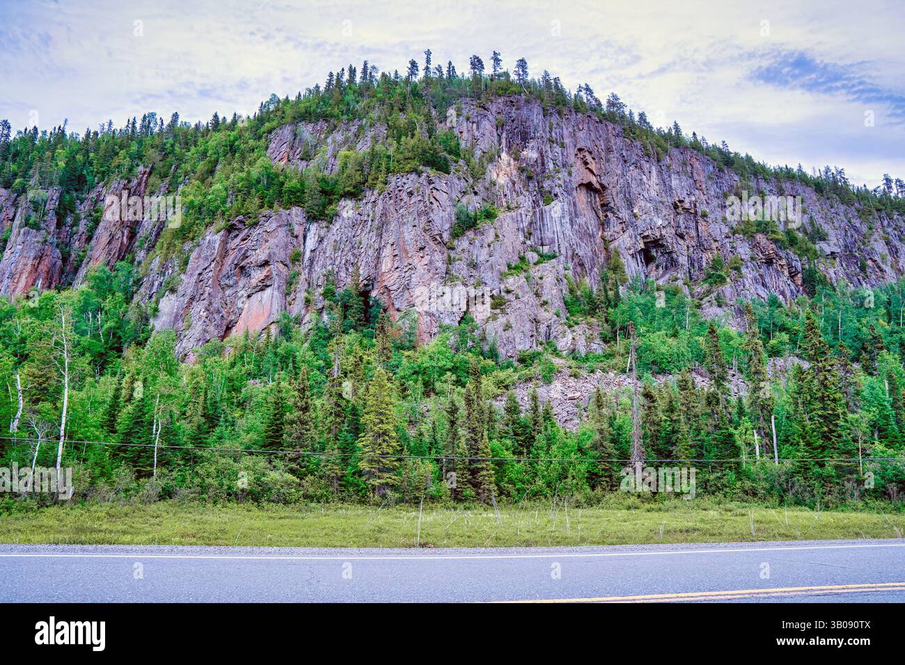 Dramatic rock cliff, of diabase sills and red Sibley rocks, are seen ...