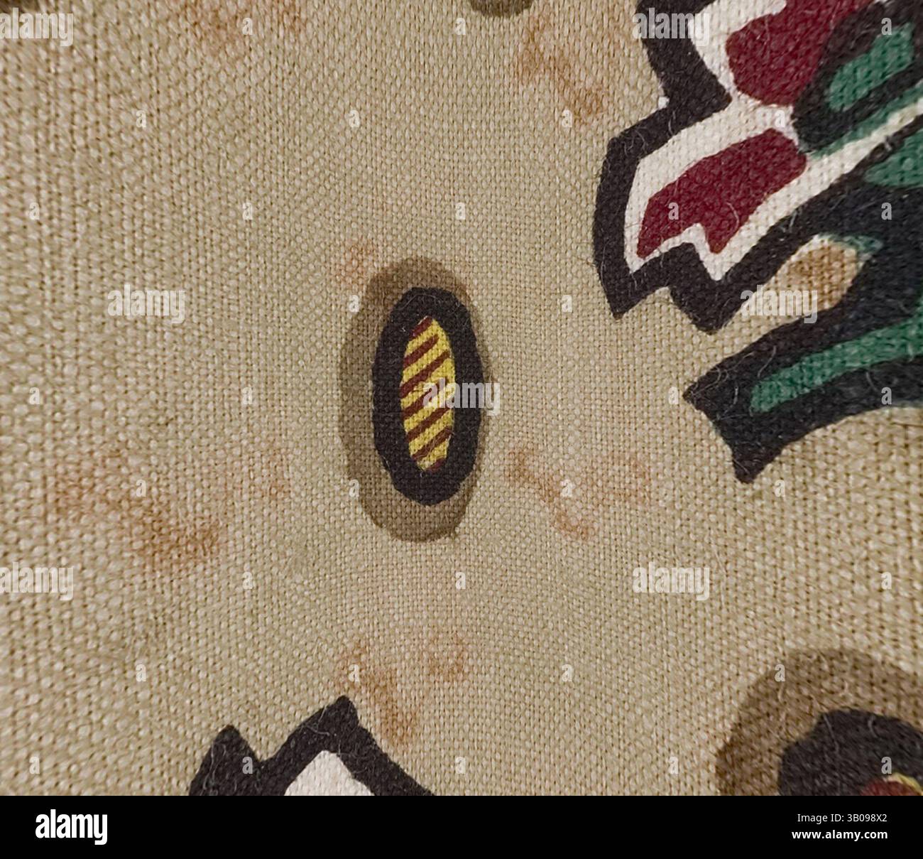 A textured fabric features a vibrant pattern with a central circular ...