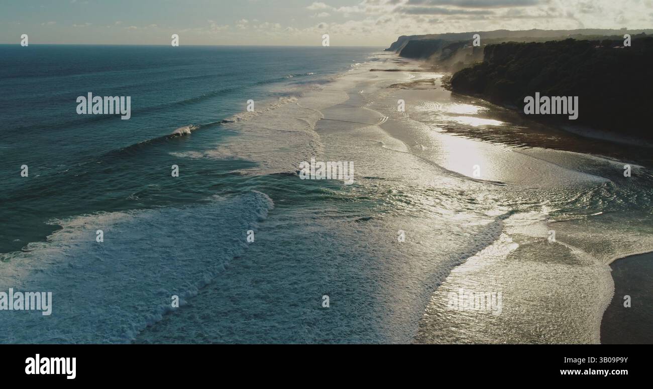 Golden hour sunlight reflecting on the ocean surface, creating a ...