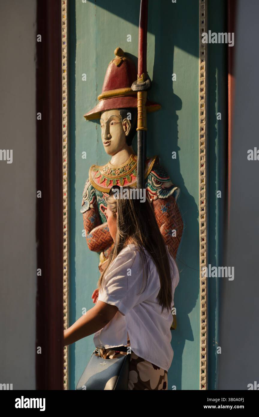 Intricate wall relief of a palace guard watches over visitors at ...