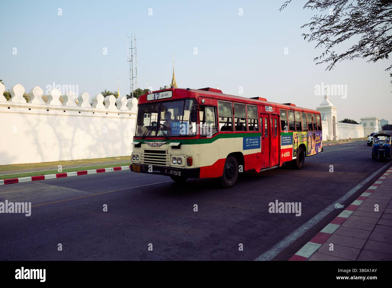Vintage red and cream bus rolls past the iconic white walls of the ...