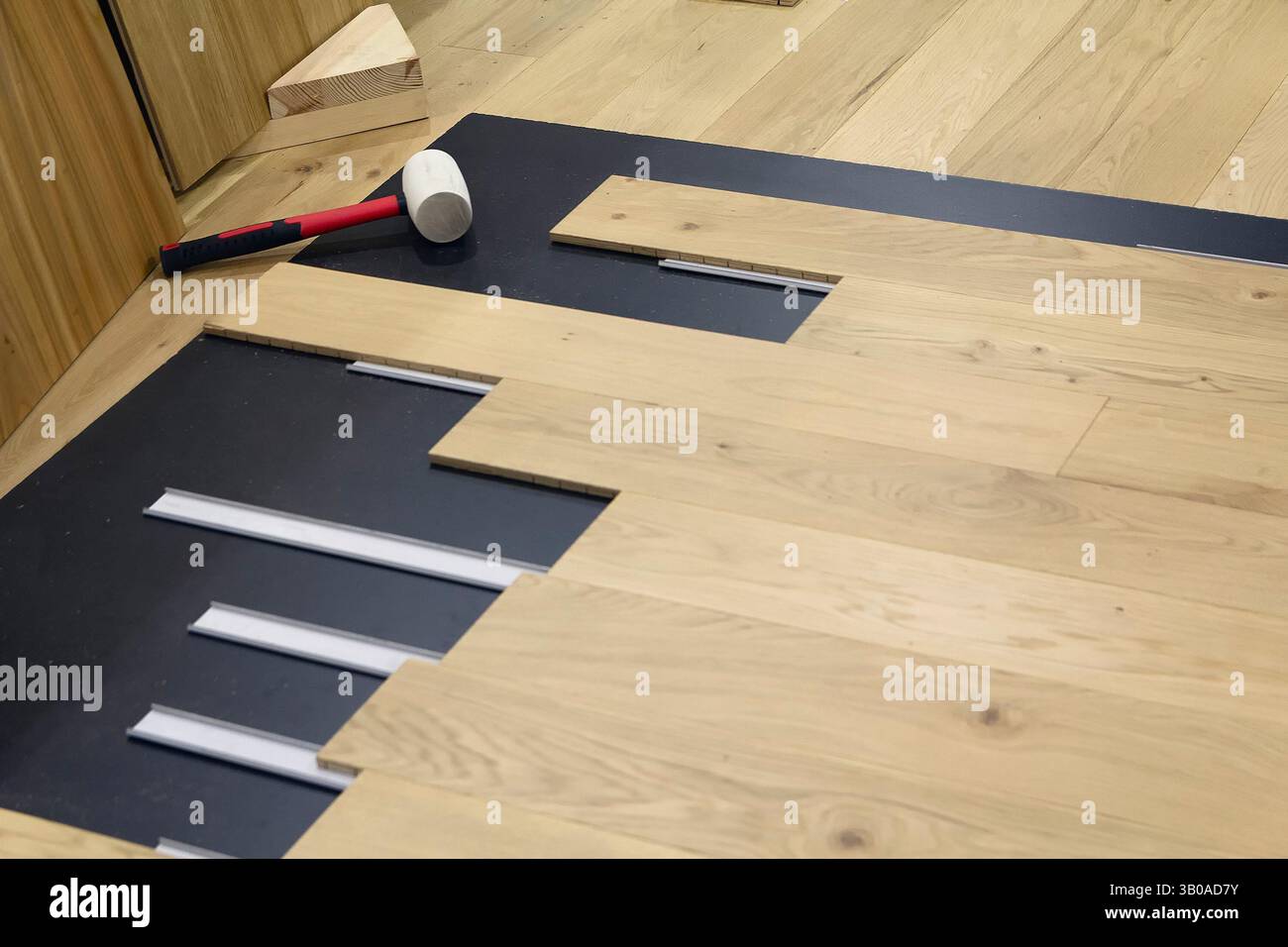 Mallet and laminate boards on floor. Construction industry Stock Photo ...