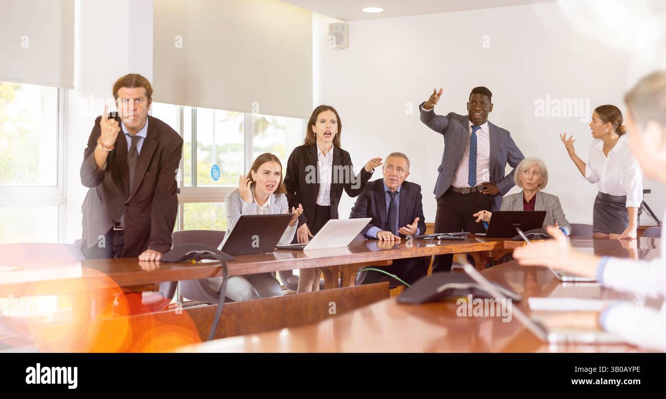 Angry business people conflicting in meeting room Stock Photo - Alamy