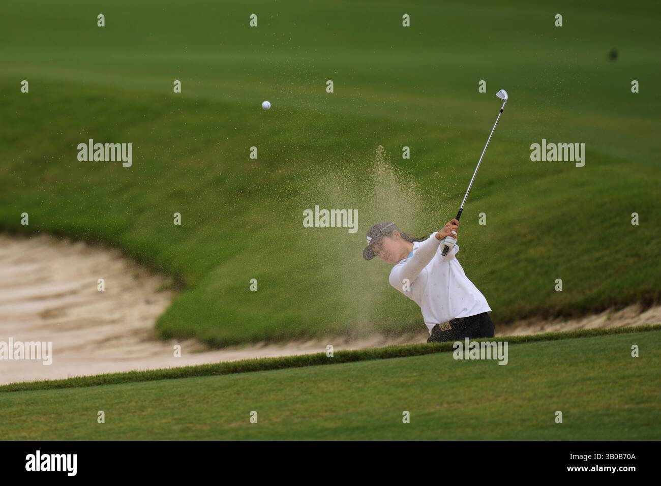 Jing Yan, of China, hits from a bunker during a practice round at the ...