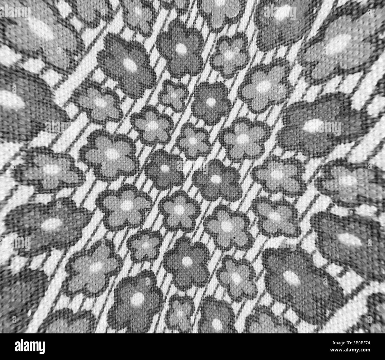 A patterned textile featuring a cascading design of floral motifs ...