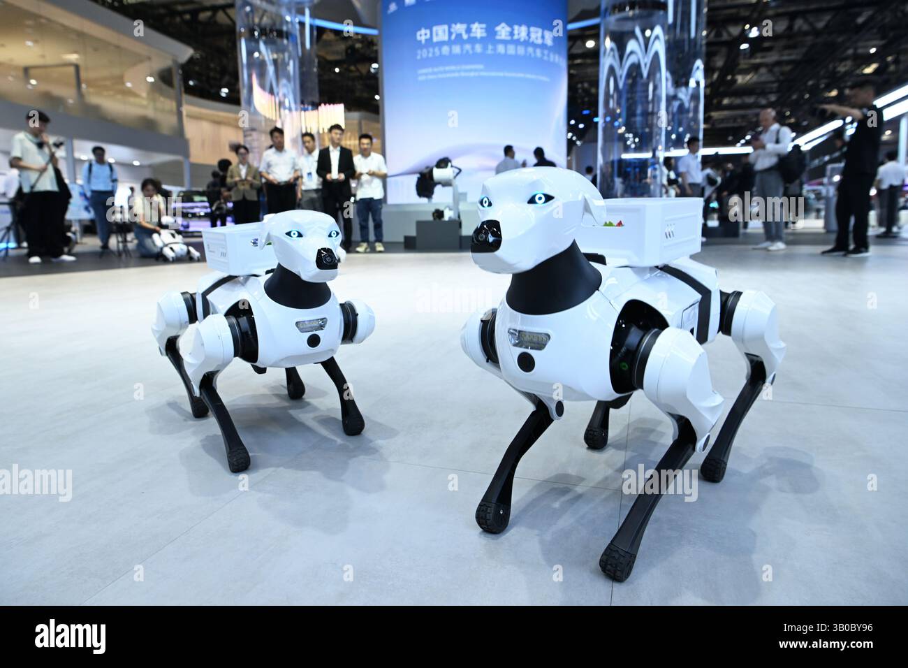 Visitors are viewing the exhibited products such as vehicles and robots ...