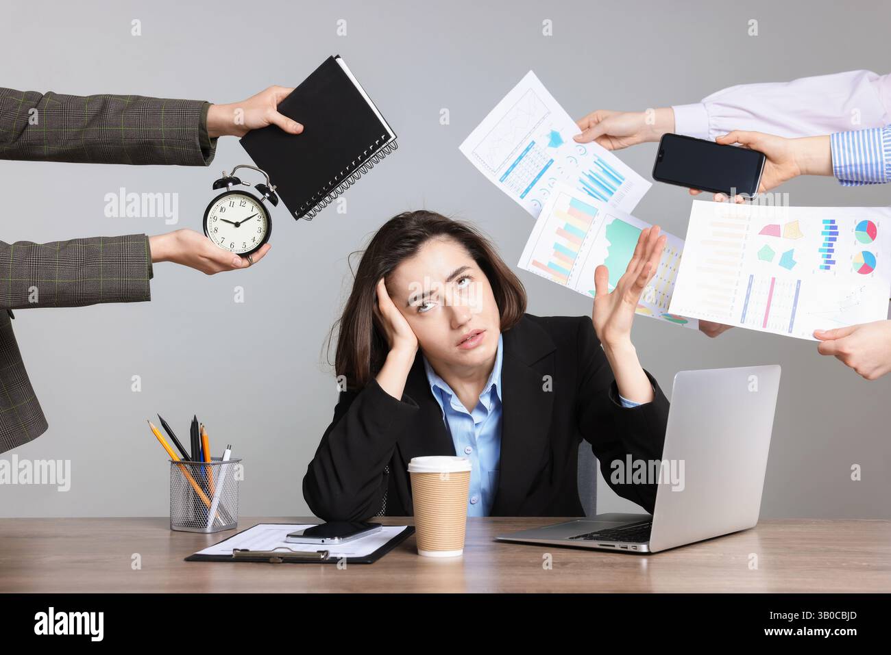 Woman overwhelmed by different requests from colleagues at desk against ...