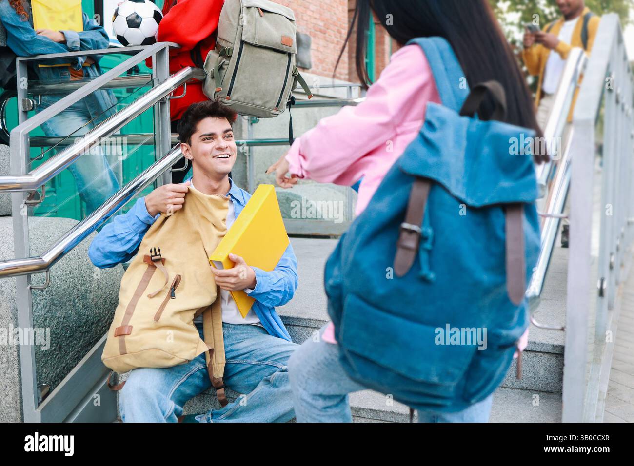 Diverse friends having fun after school class on campus university . Group of students talk ...