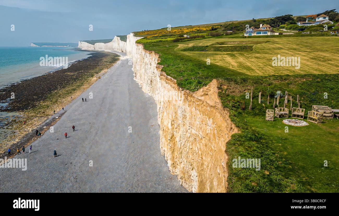 Busy Birling Gap in East Sussex, UK—showing iconic chalk cliffs, beach ...
