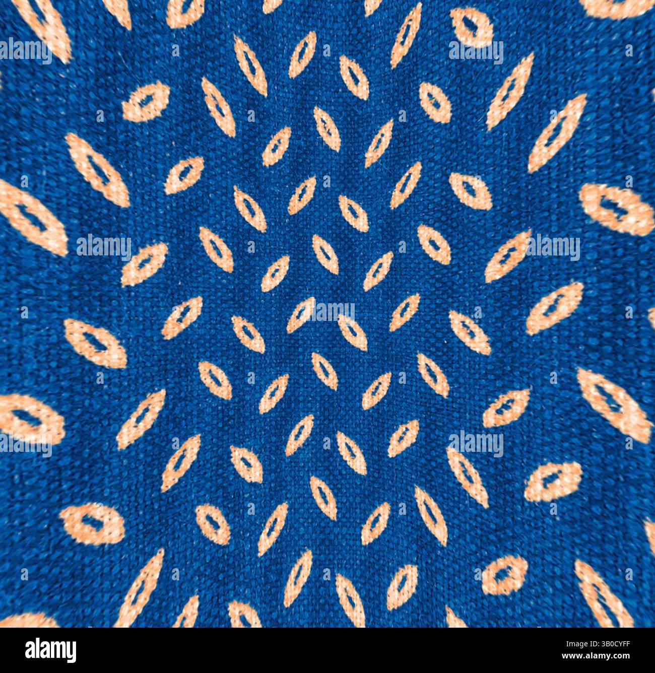 A vibrant blue fabric adorned with a repetitive pattern of golden eye ...