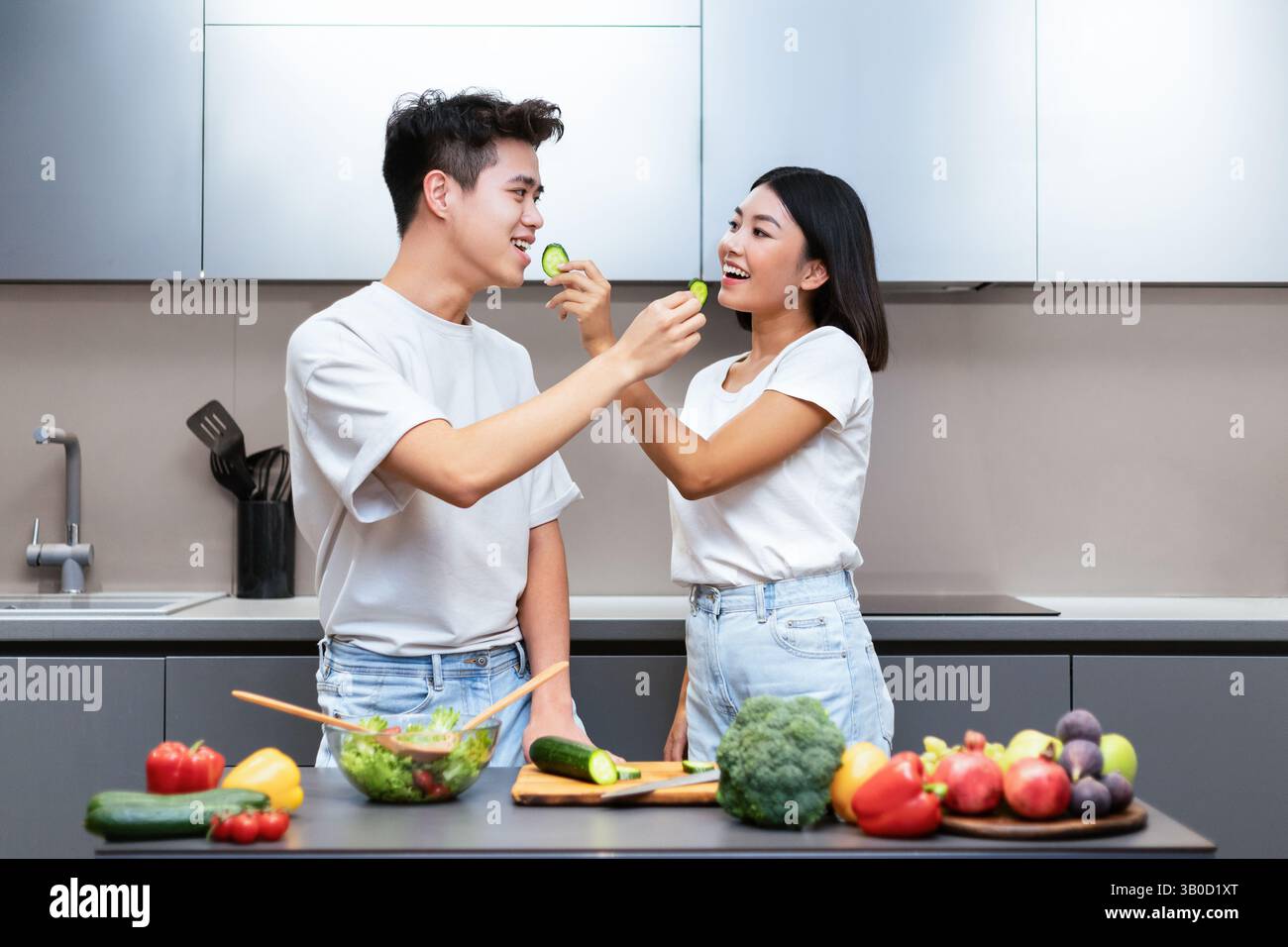 Japanese Couple Cooking Feeding Each Other Tasting Dinner In Kitchen ...