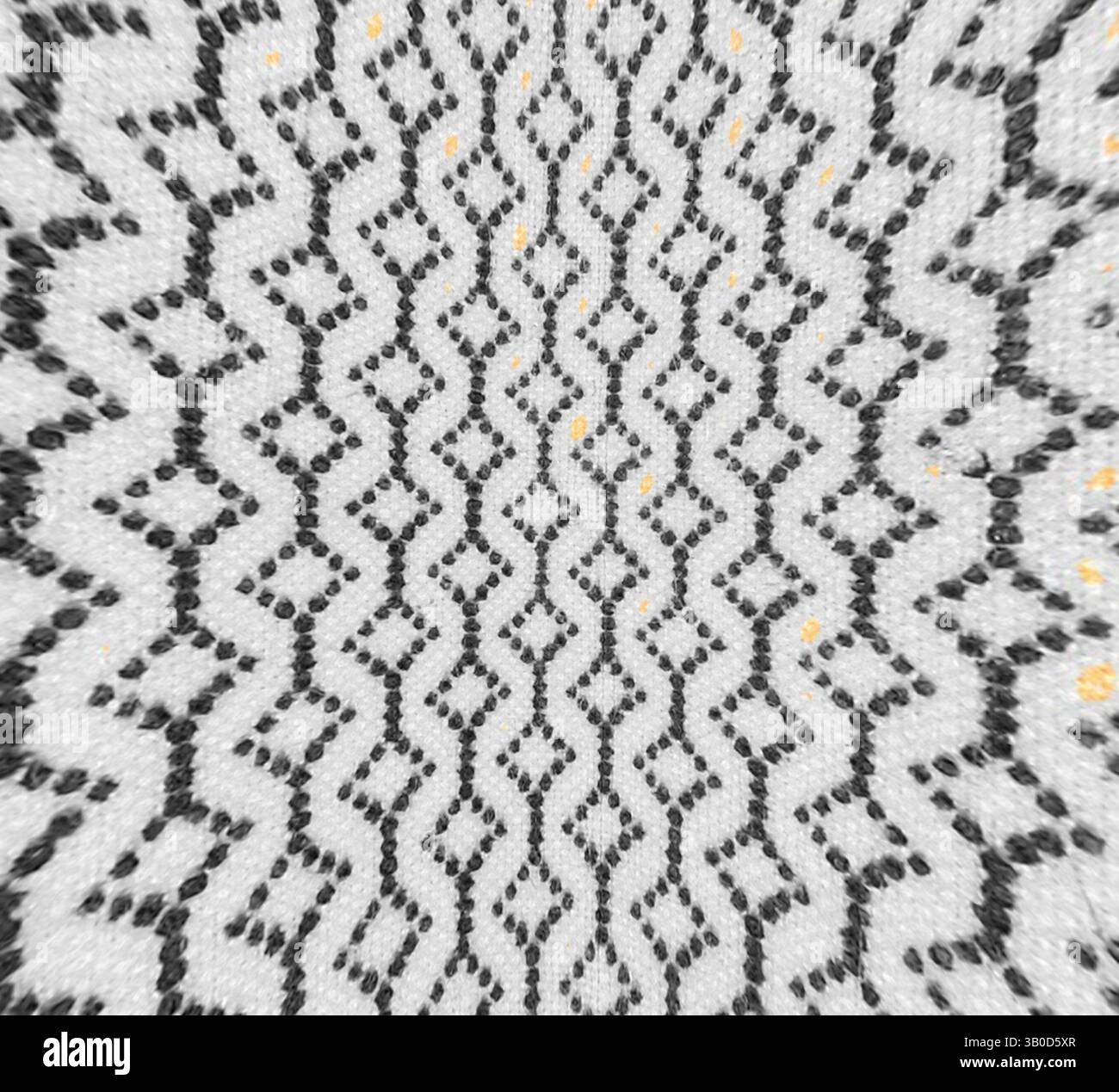 A textured surface showcases an intricate pattern of interwoven lines ...