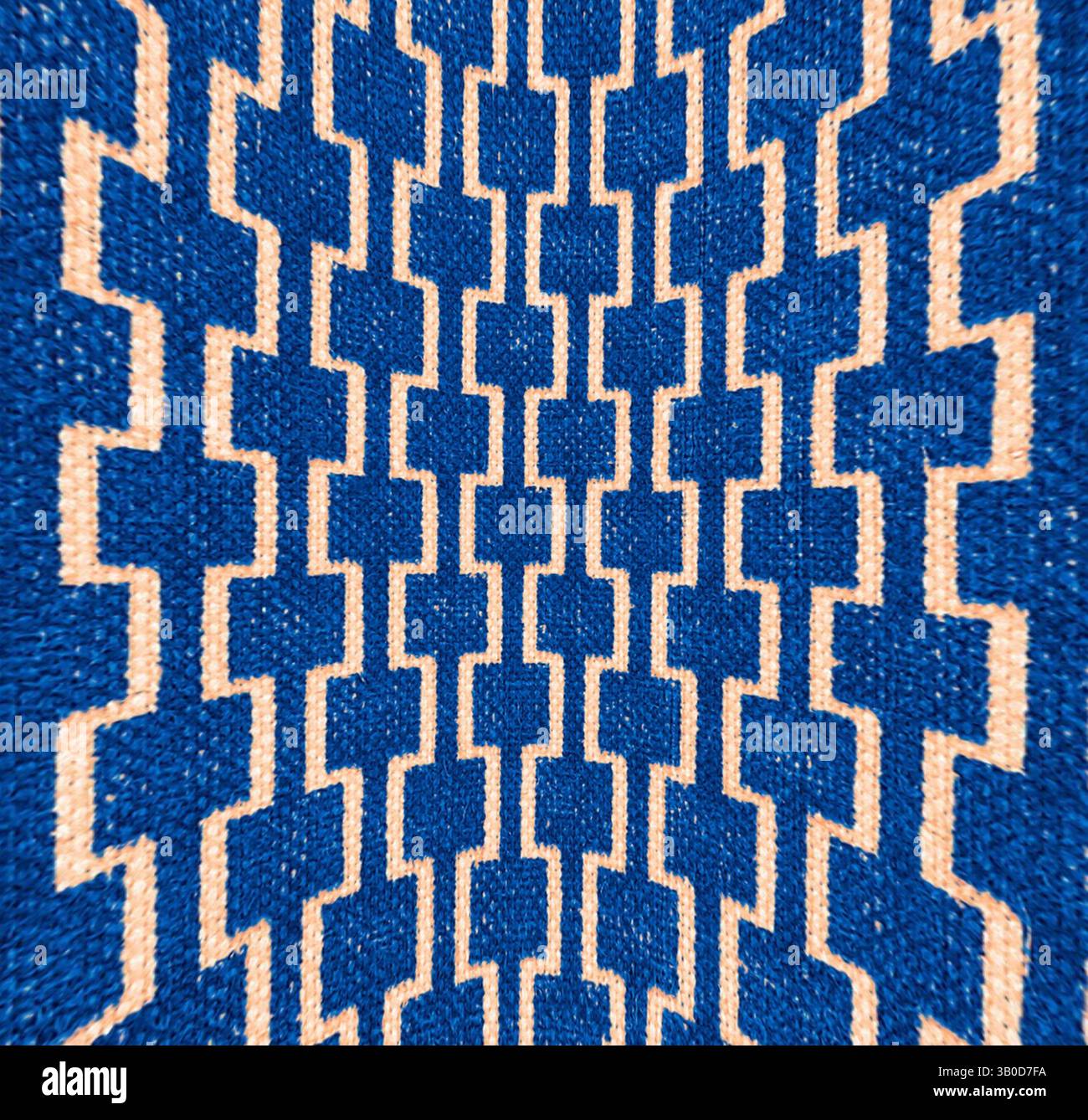 A vibrant pattern of alternating blue and cream shapes creates a ...