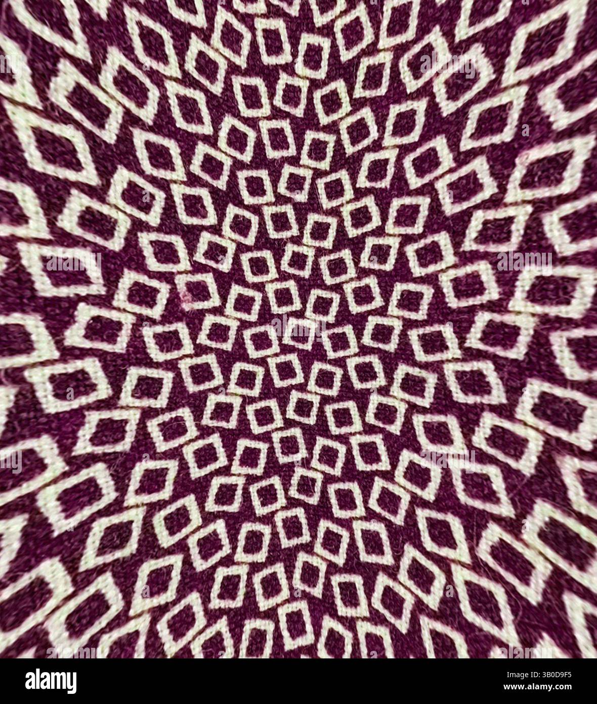 A textured fabric showcases a repeating diamond pattern in rich maroon ...