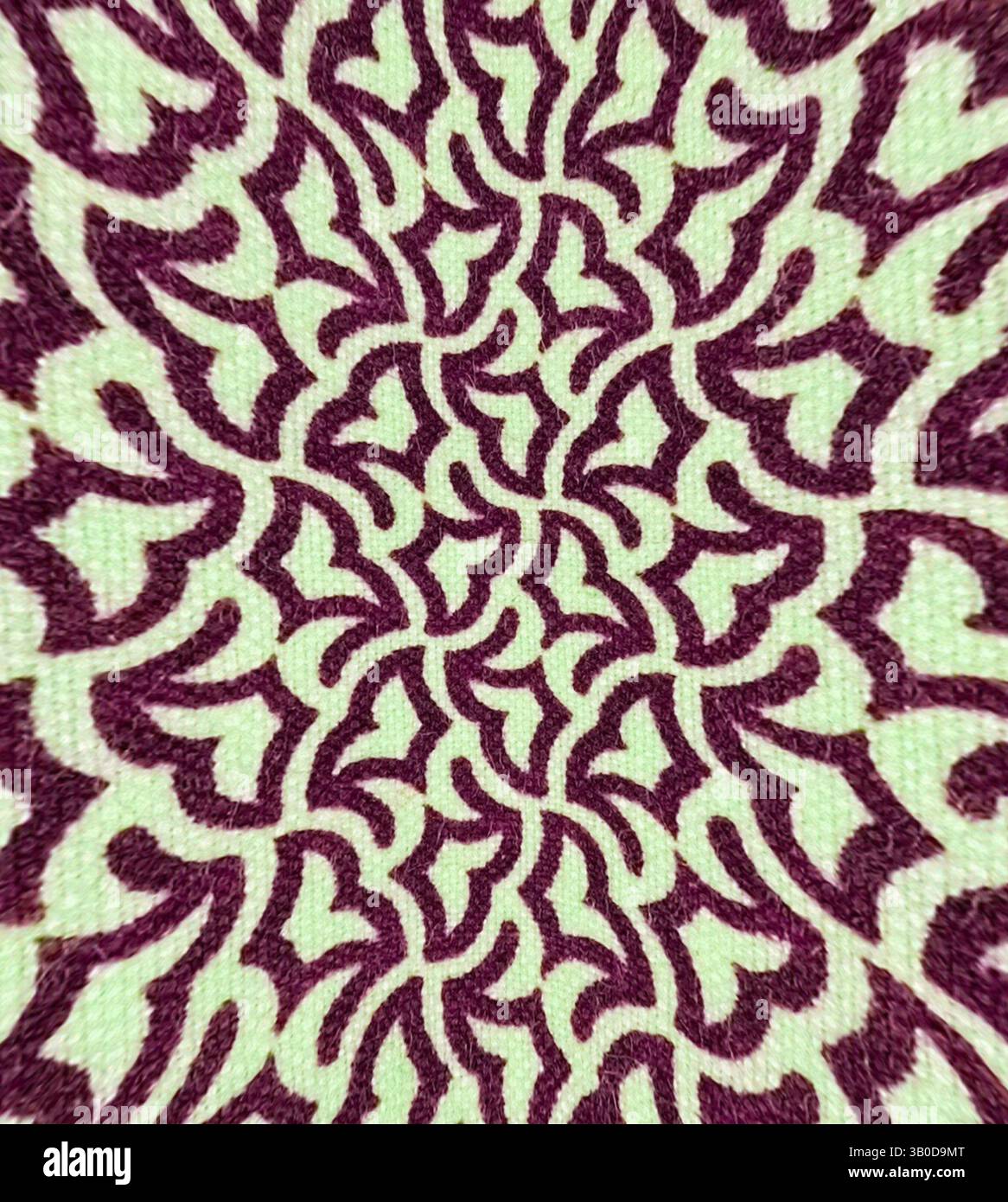 An intricate pattern of swirling shapes in deep maroon against a light ...