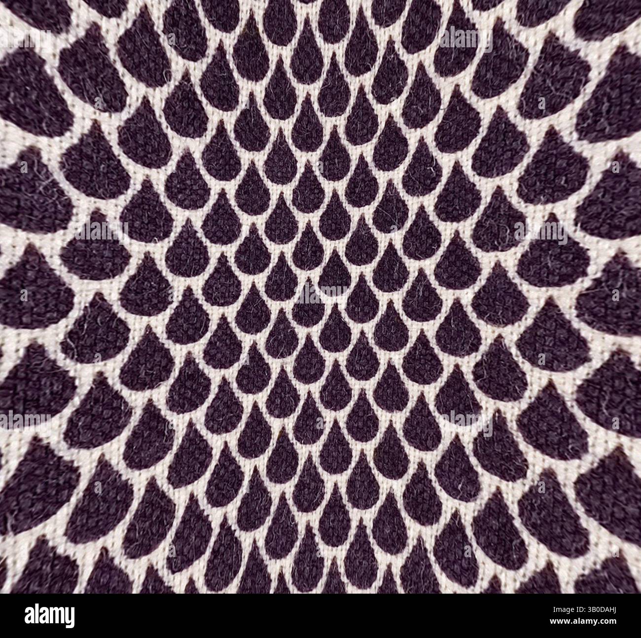 A repeating pattern of teardrop shapes, arranged in a grid-like fashion ...