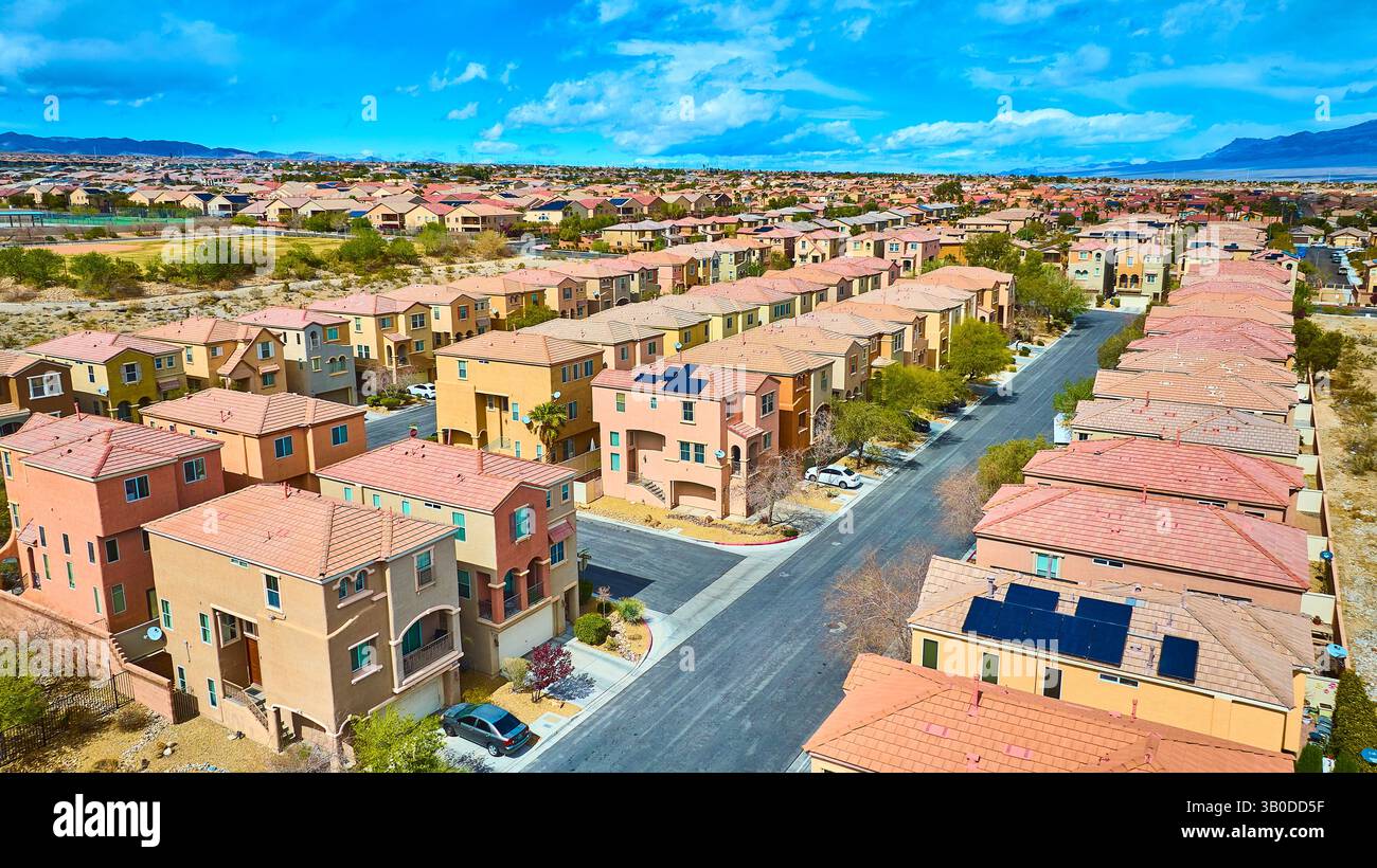 Aerial of Suburban Desert Community with Solar Panels and Mountains ...