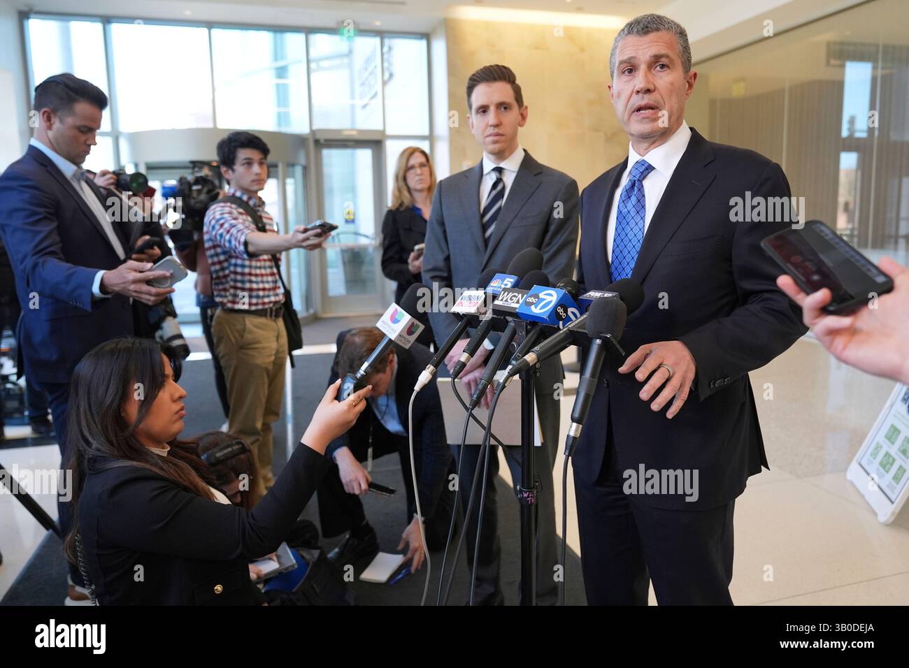 Victim's family attorney Antonio Romanucci, right, speaks at a news ...