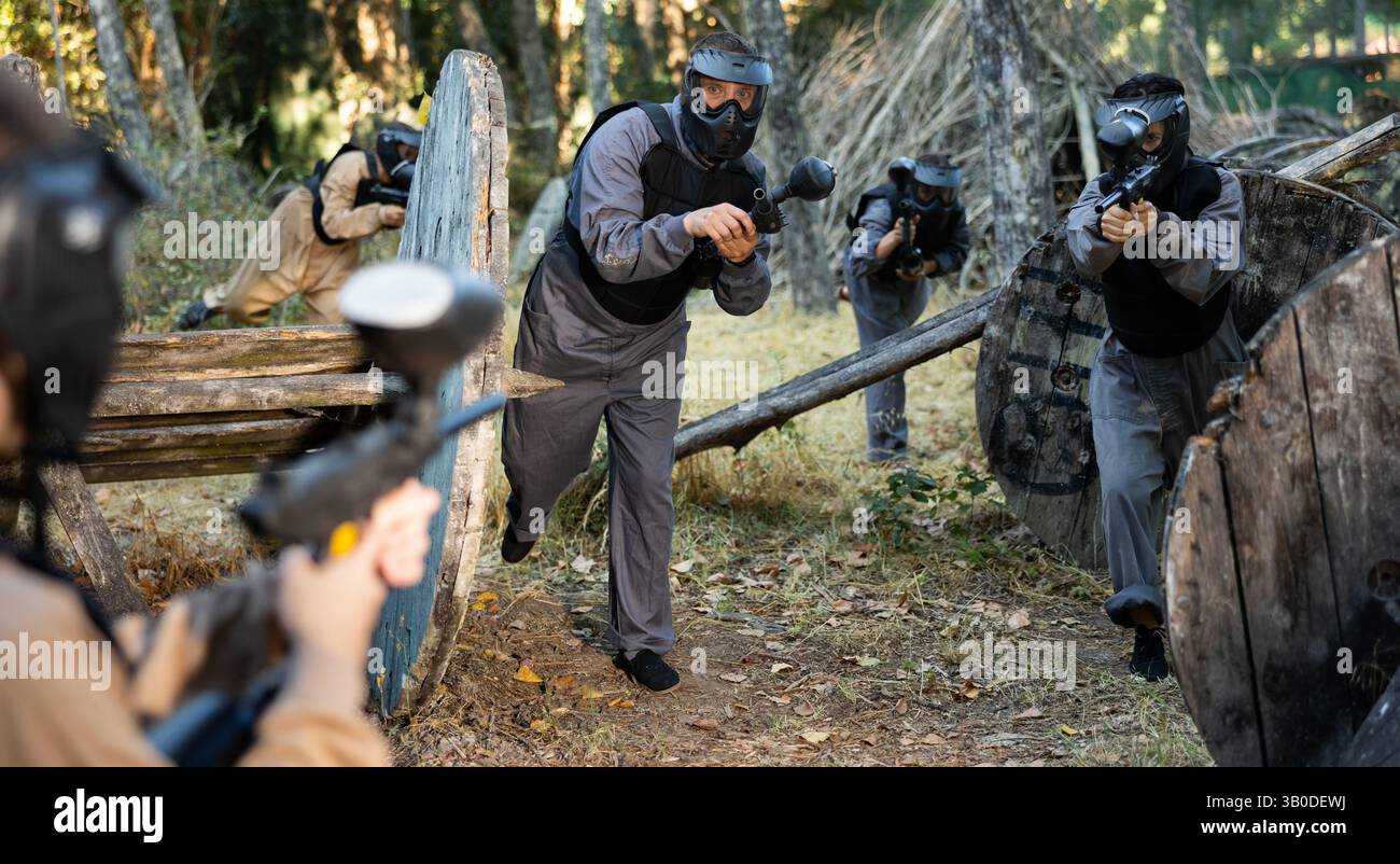 Tactical paintball team fighting on outdoor location Stock Photo - Alamy