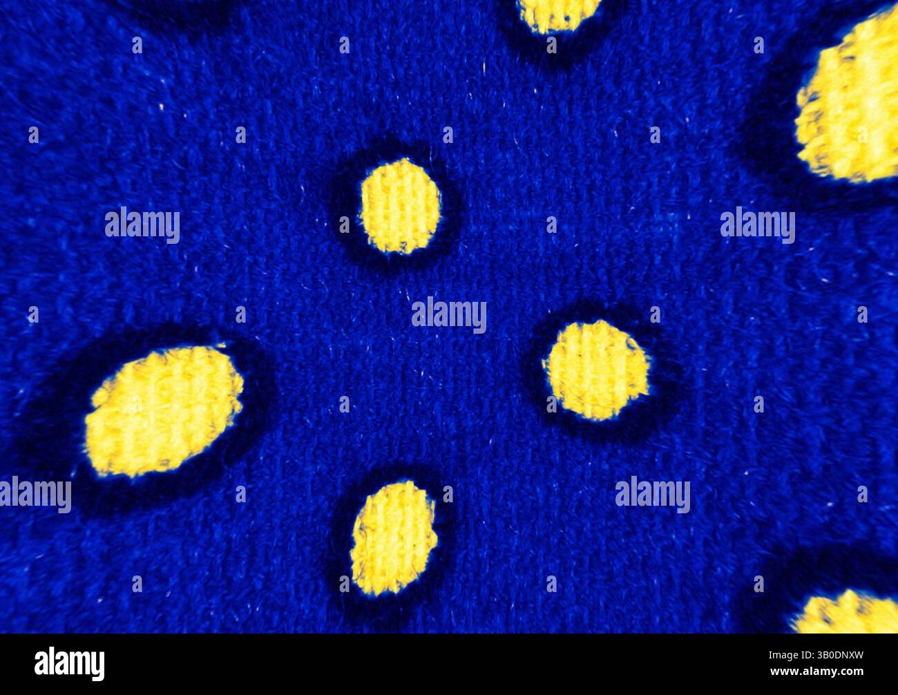 A vibrant blue surface dotted with bright yellow circles creates a ...