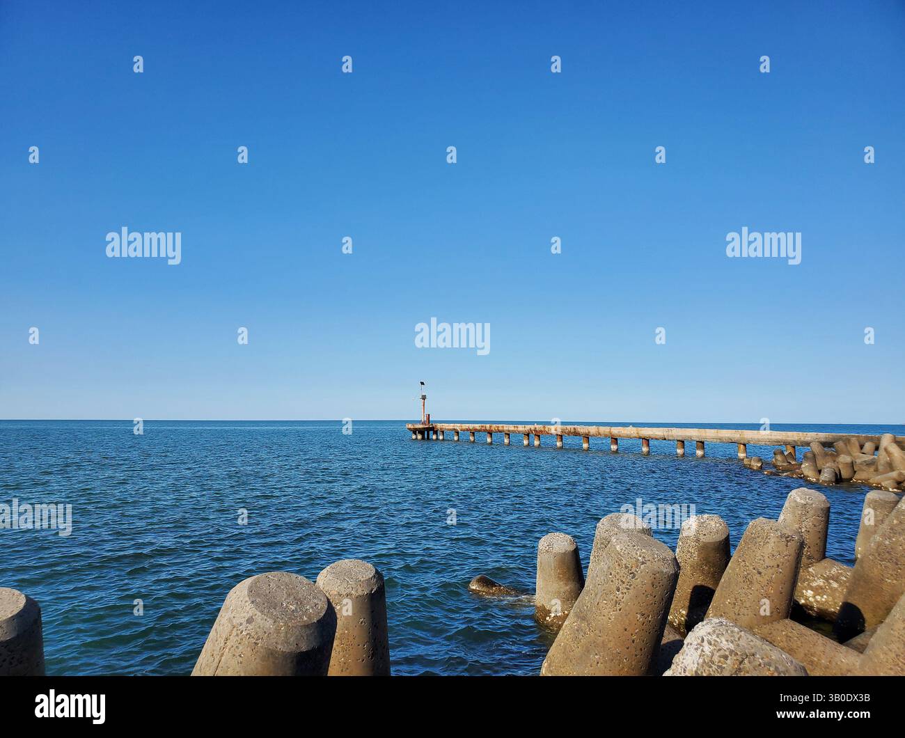 Tidal Gauge Pier and Concrete Tetrapods on Coastal Horizon Stock Photo ...