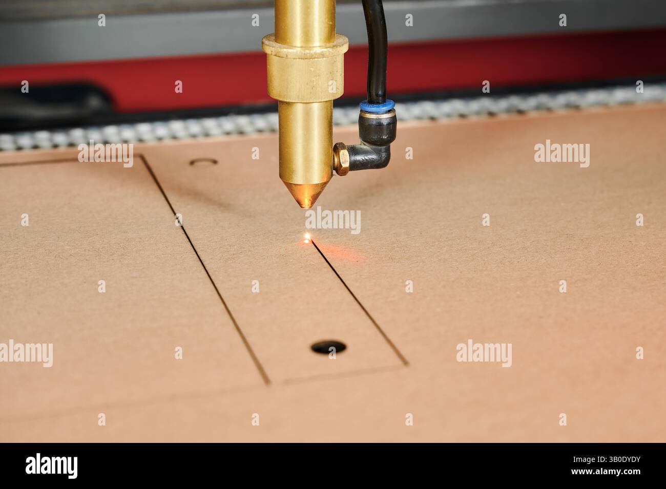 Precision laser cutting transforms cardboard sheets in a busy ...