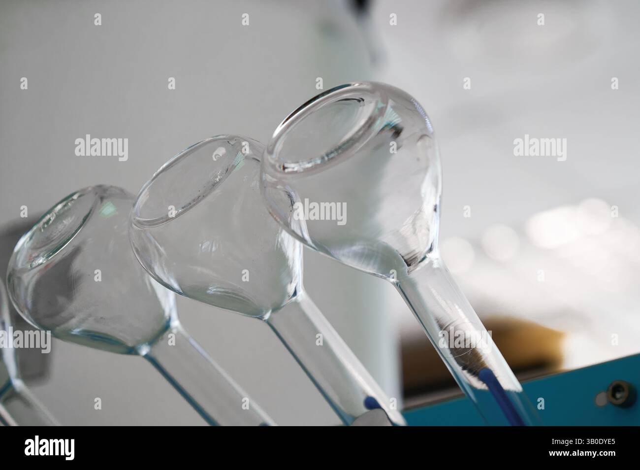 Clean glass laboratory equipment arranged neatly on a lab bench in a ...