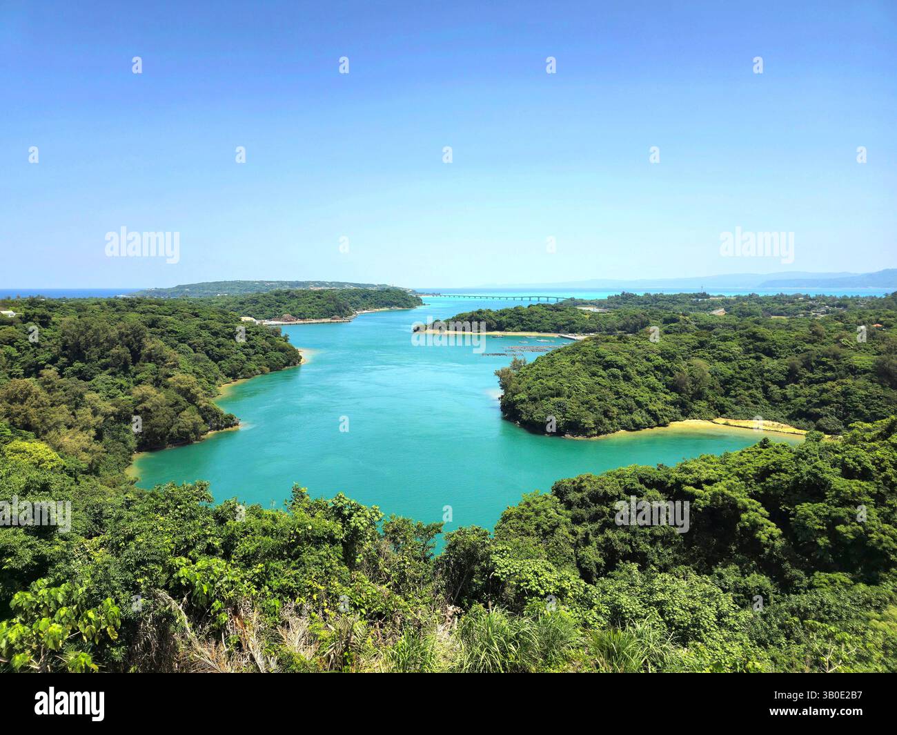 A picturesque scene of a coastal lagoon surrounded by lush vegetation ...
