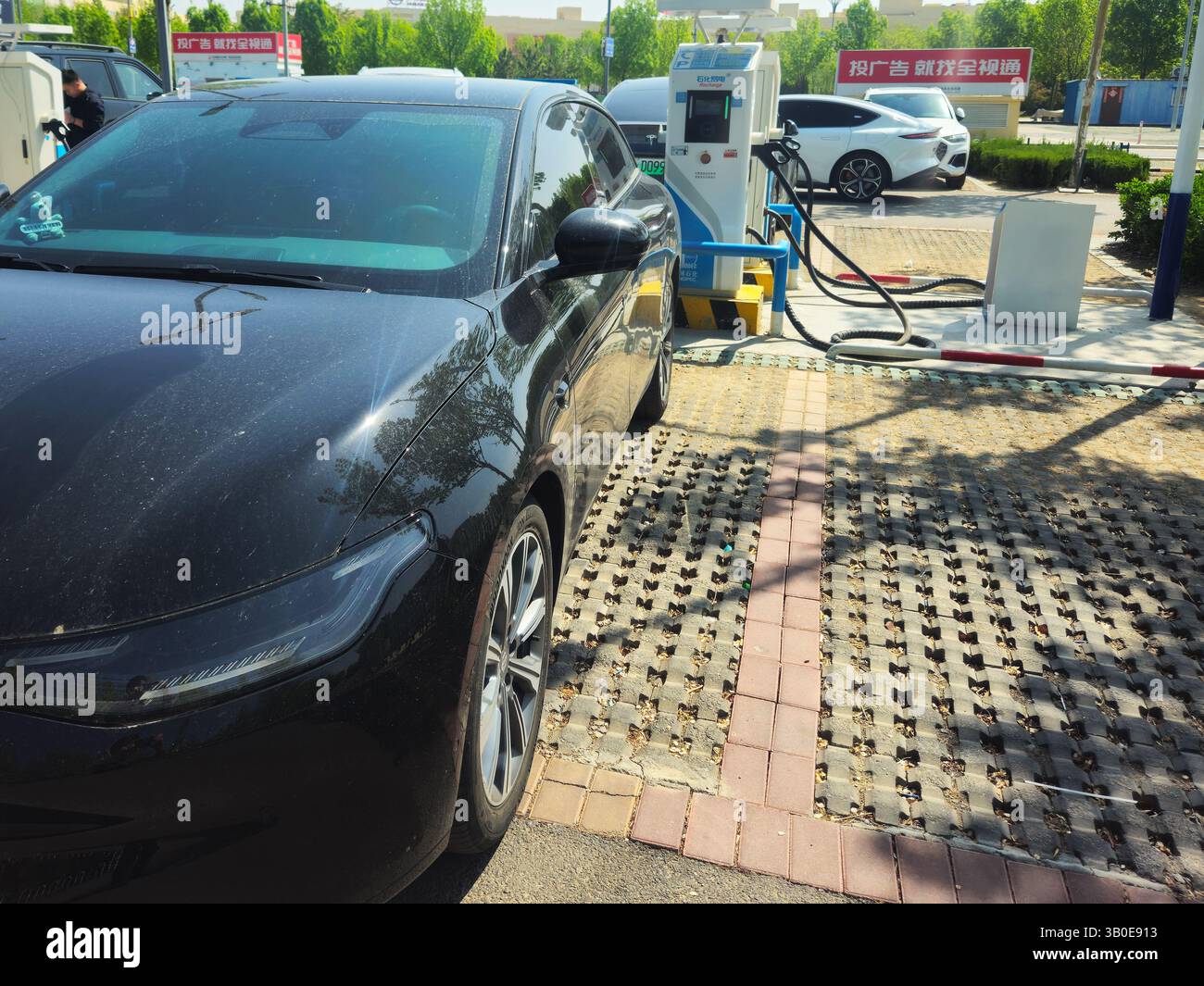 Electric Sedan Charging at Sinopec Recharge Station in Urban China ...