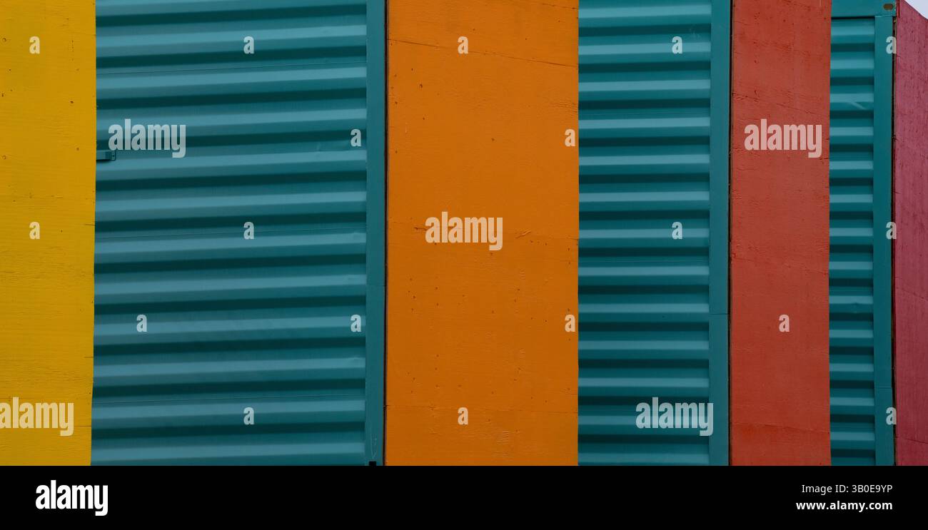 close up of sides of shipping containers painted red turquoise yellow ...