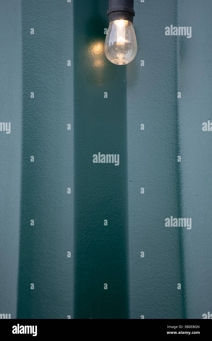 Vertical image of electric light bulb lit light is shining and ...