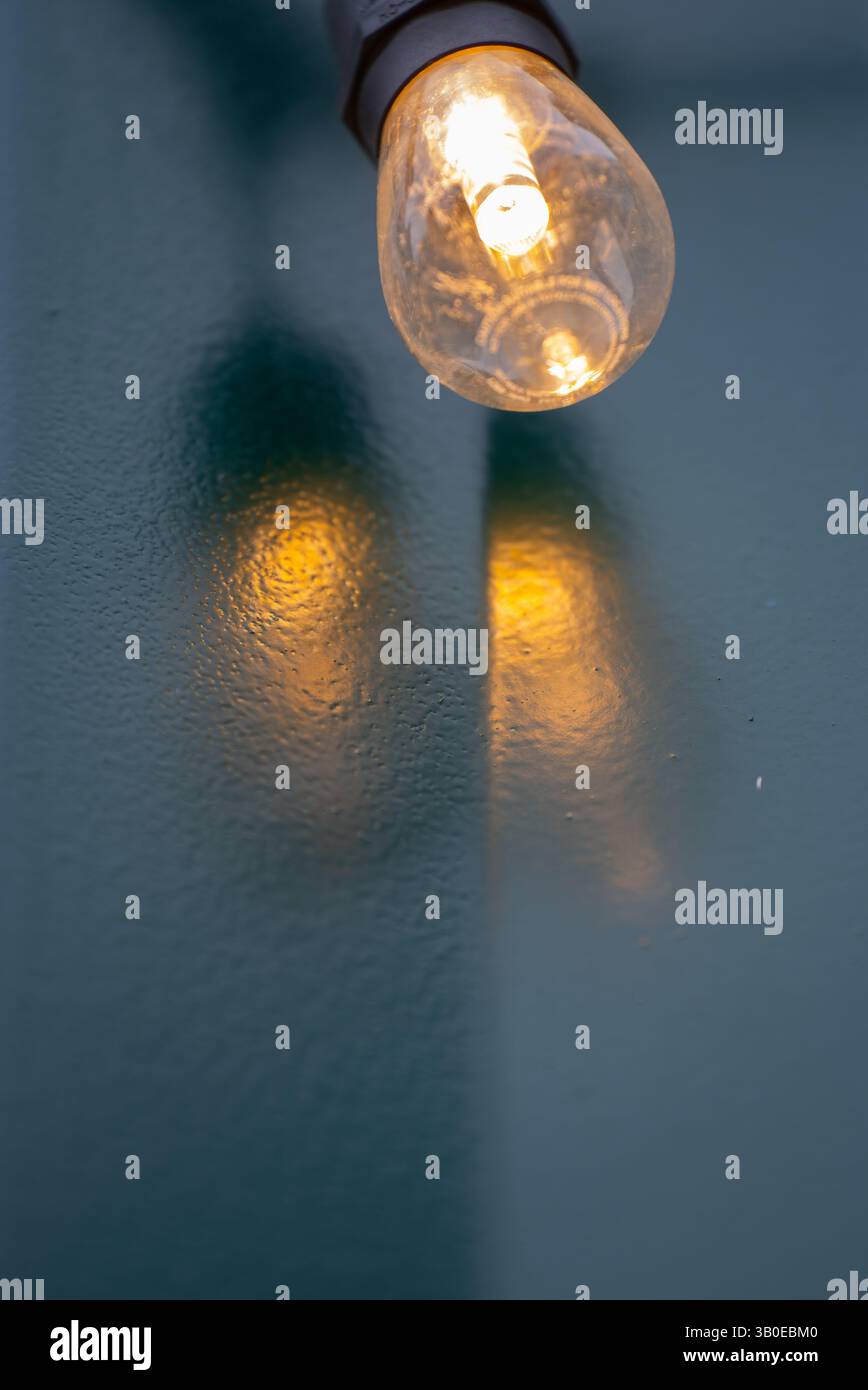 Vertical image of electric light bulb lit light is shining and ...