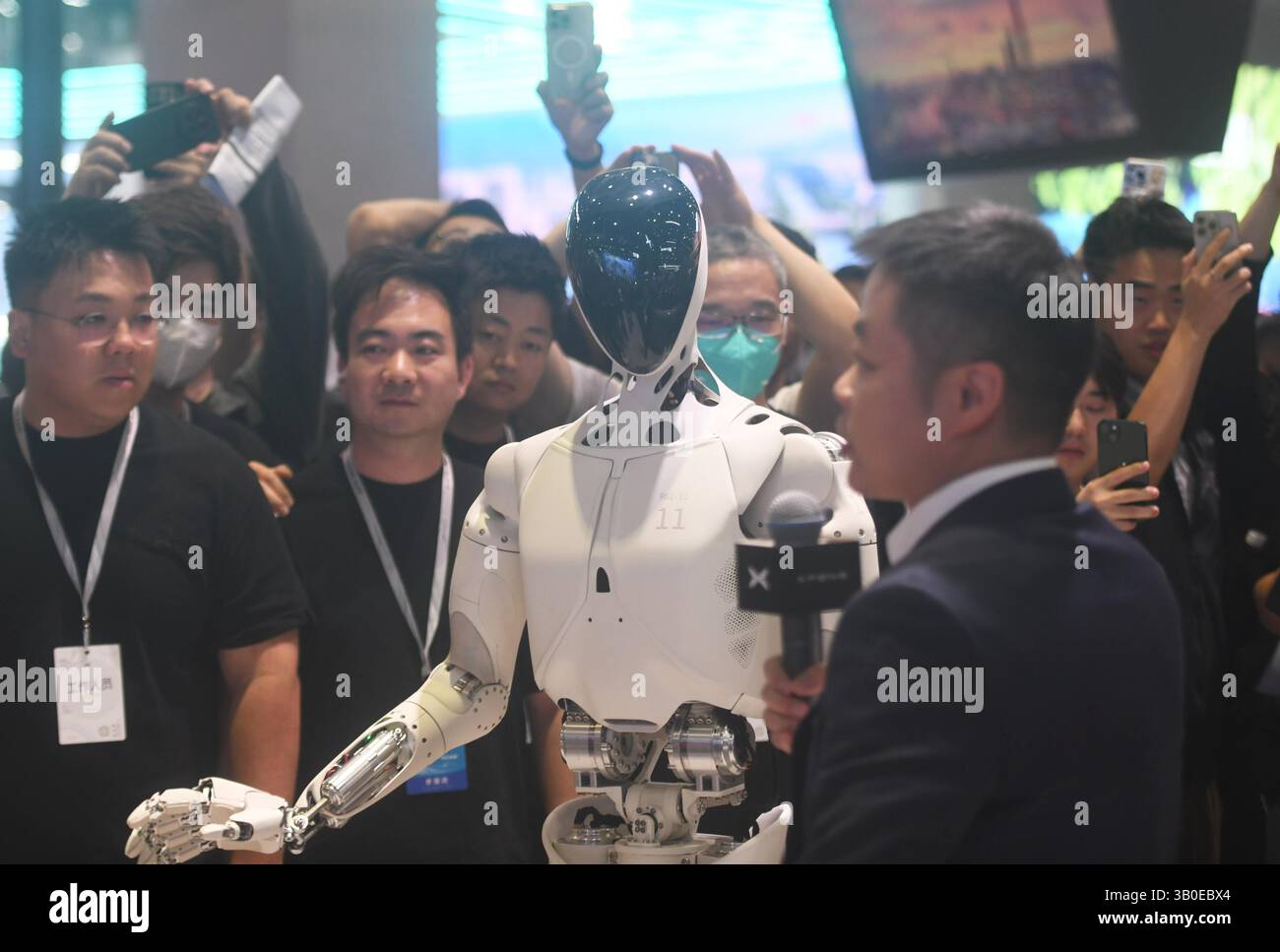 People watch the Xpeng's humanoid robot "IRON" at the Auto Shanghai ...