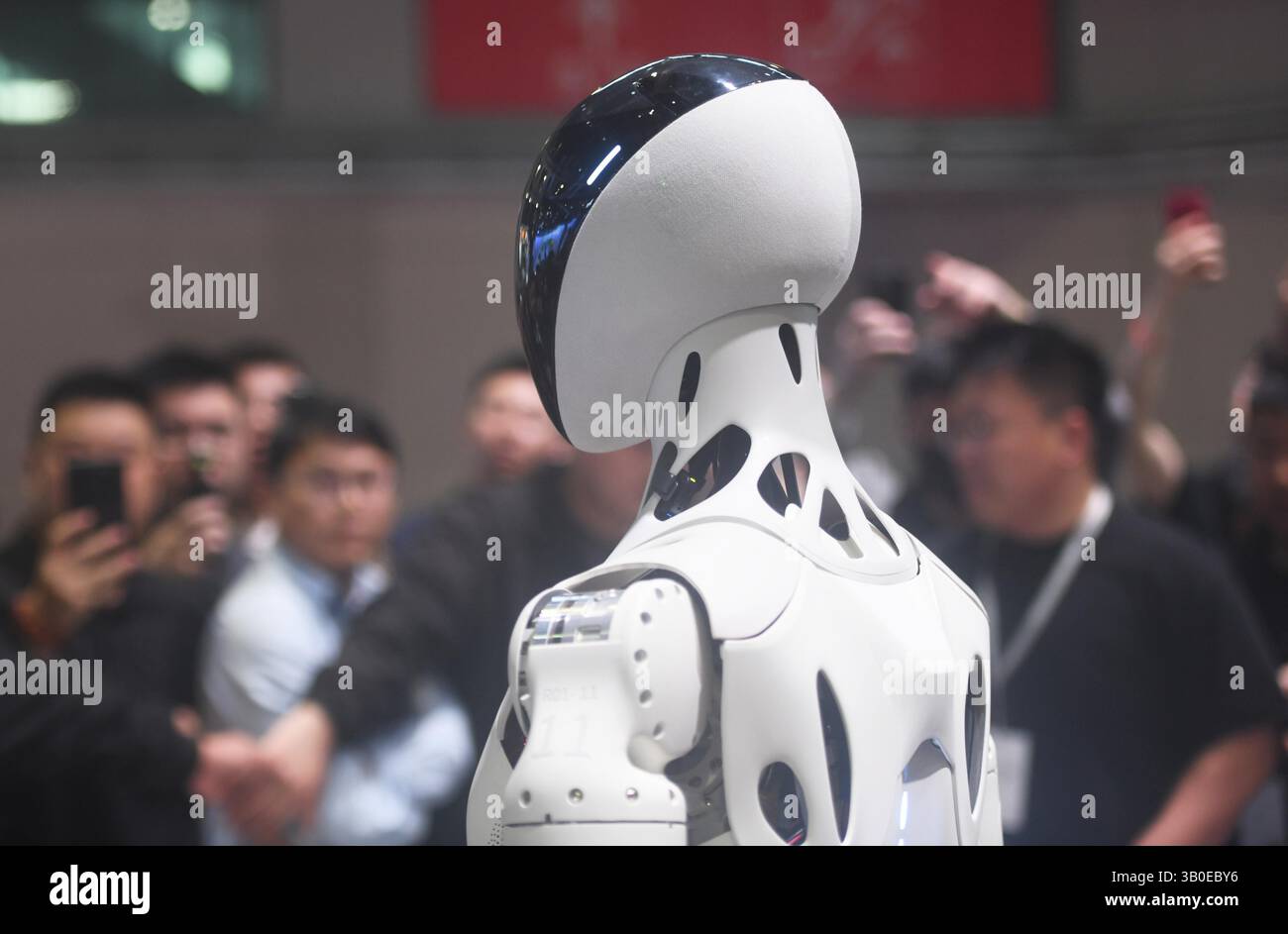 People watch the Xpeng's humanoid robot "IRON" at the Auto Shanghai ...