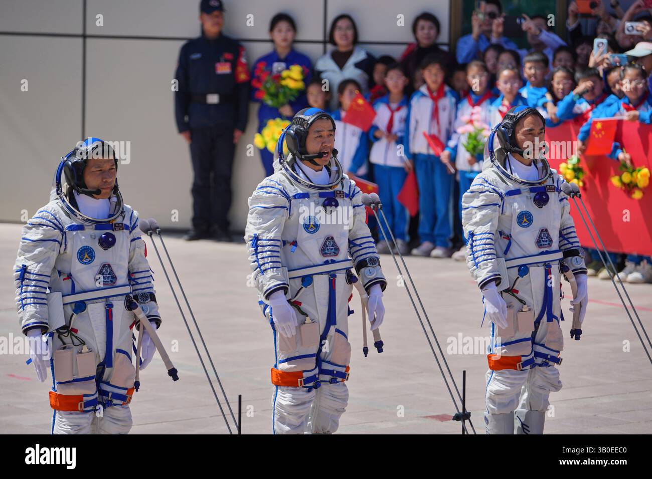 Chinese astronaut for the Shenzhou 20 mission, Chen Dong, center, speaks next to his comrades ...