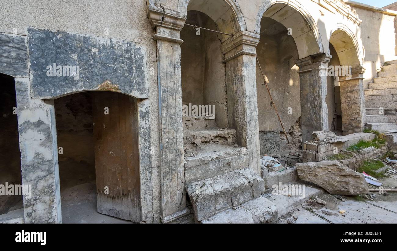 Warn torn stone ruins with arches and columns, showing signs of decay ...