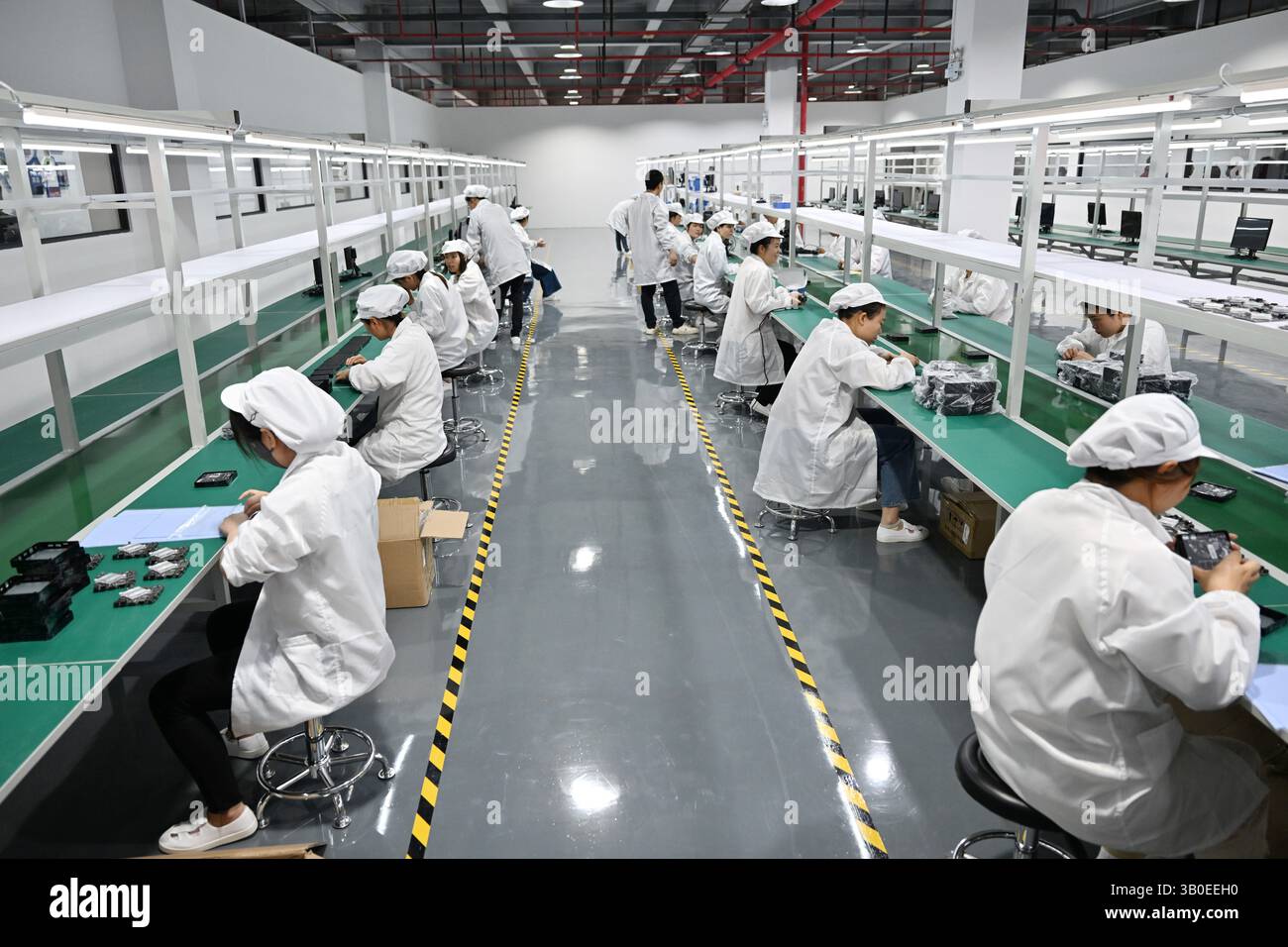 Chengdu,China.23rd April 2025. Workers assemble intelligent cloud boxes ...