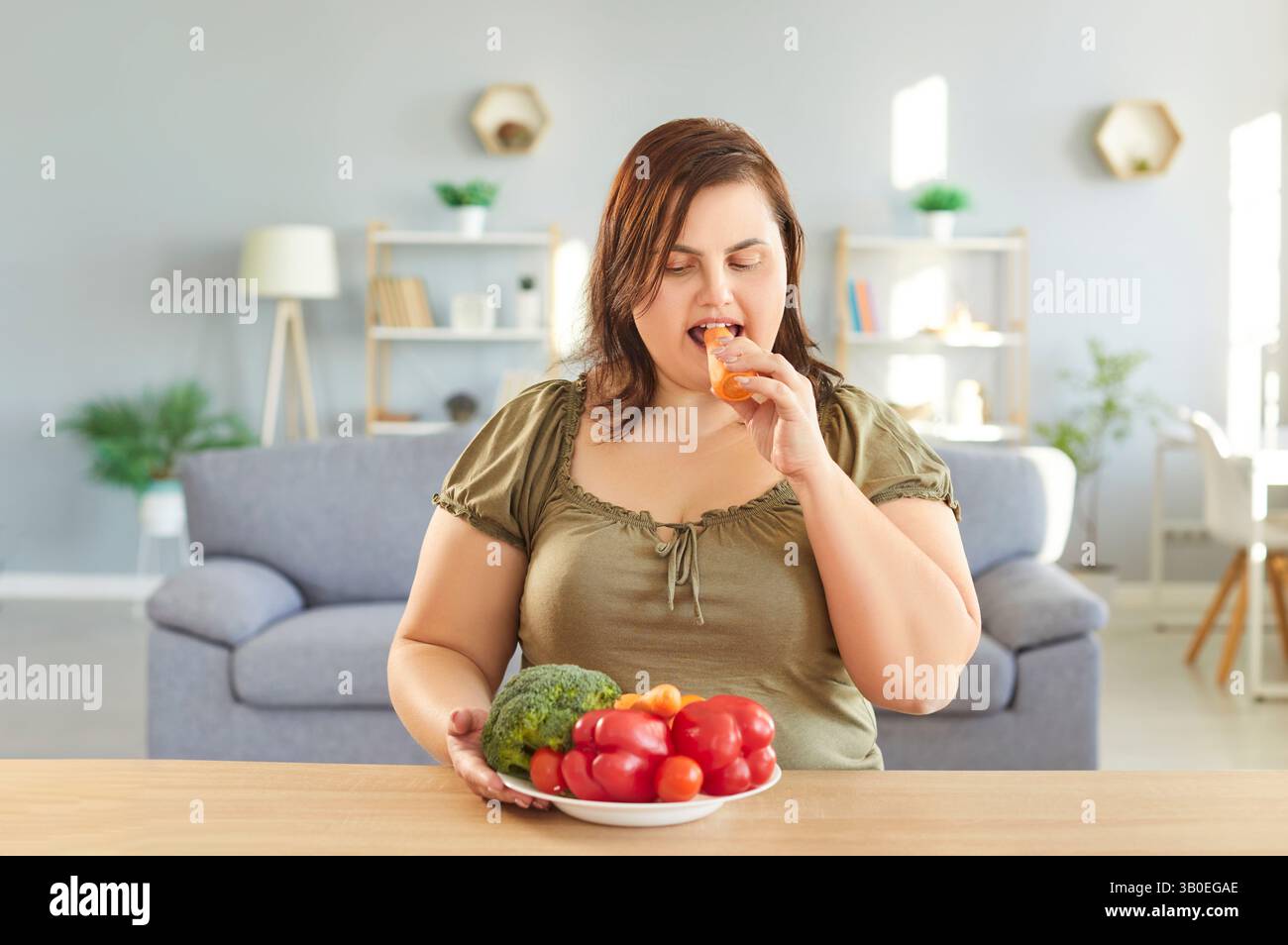 Plump overweight woman eating vegetables, trying to have healthy ...