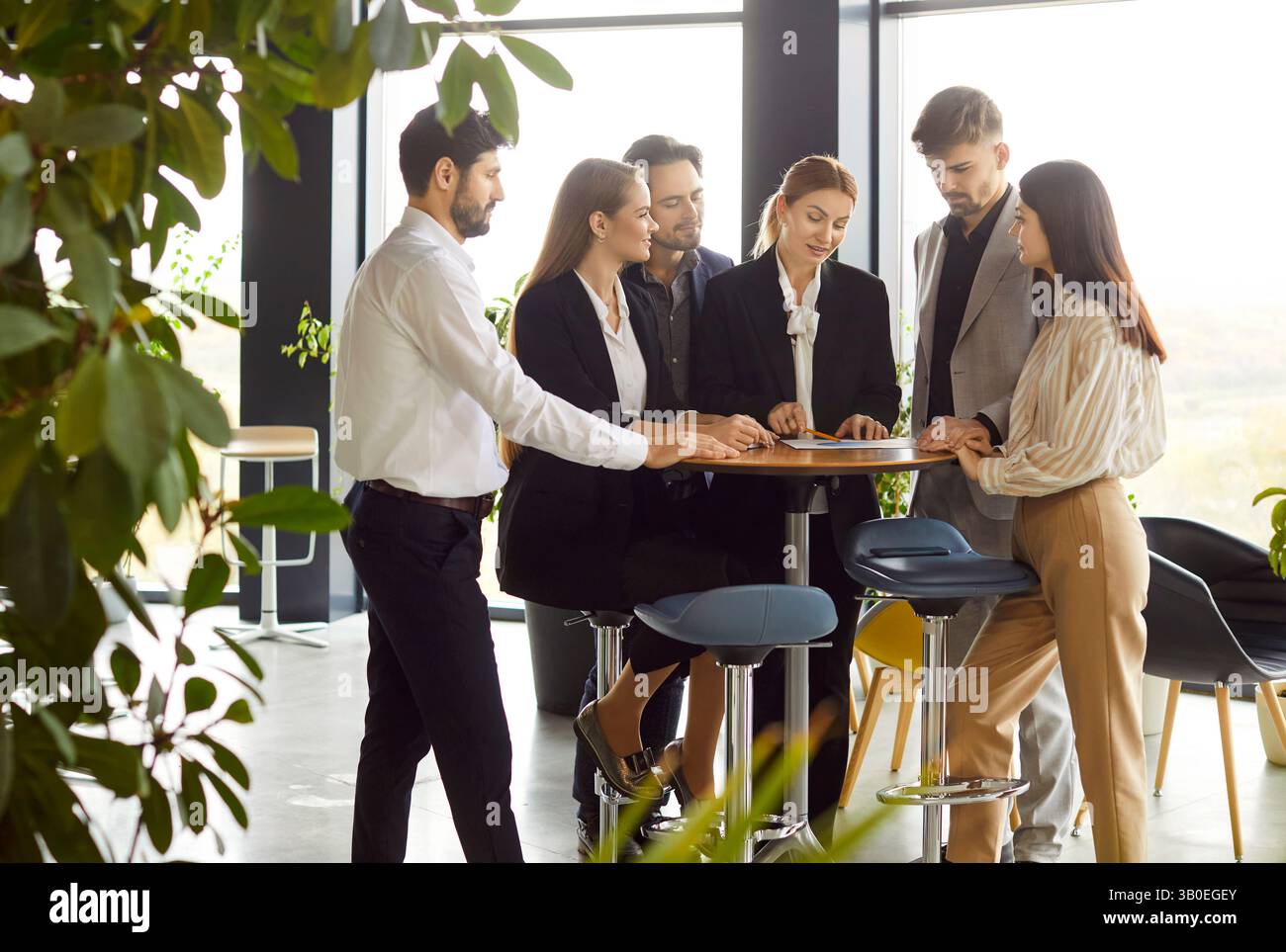 Diverse business people discussing documents hi-res stock photography ...