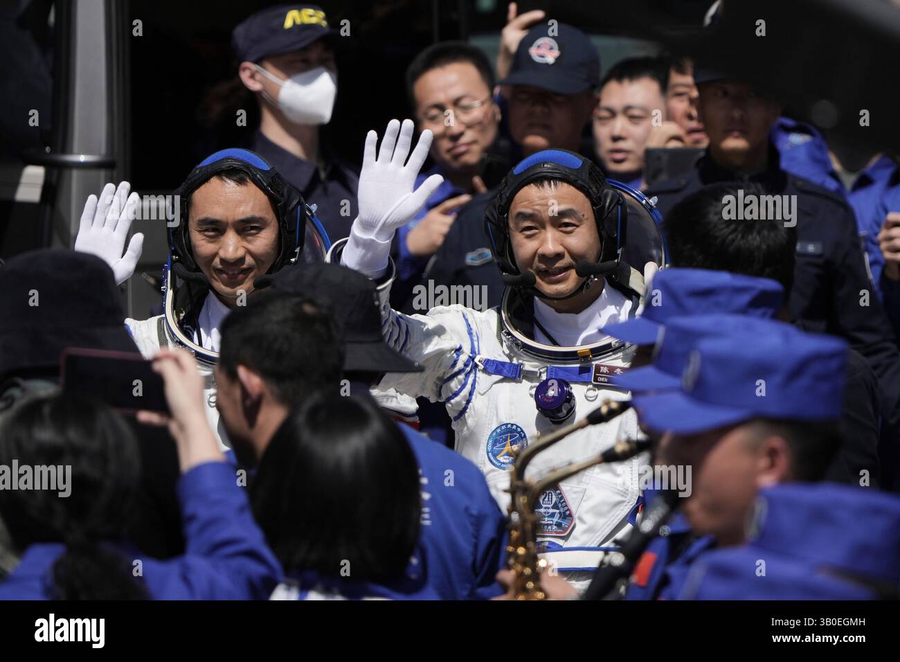 Chinese astronauts for the Shenzhou-20 mission Chen Dong, right, and Chen Zhongrui wave during a ...