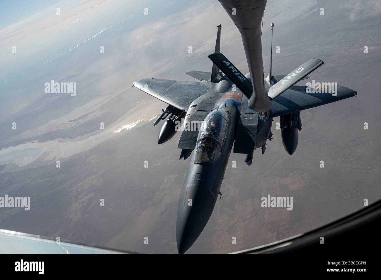 A U.S. Air Force F-15E Strike Eagle maneuvers to be refueled over the U ...