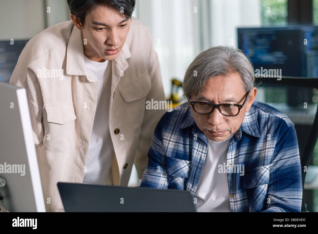 Group of asian senior in a collaborative software development analyzing ...